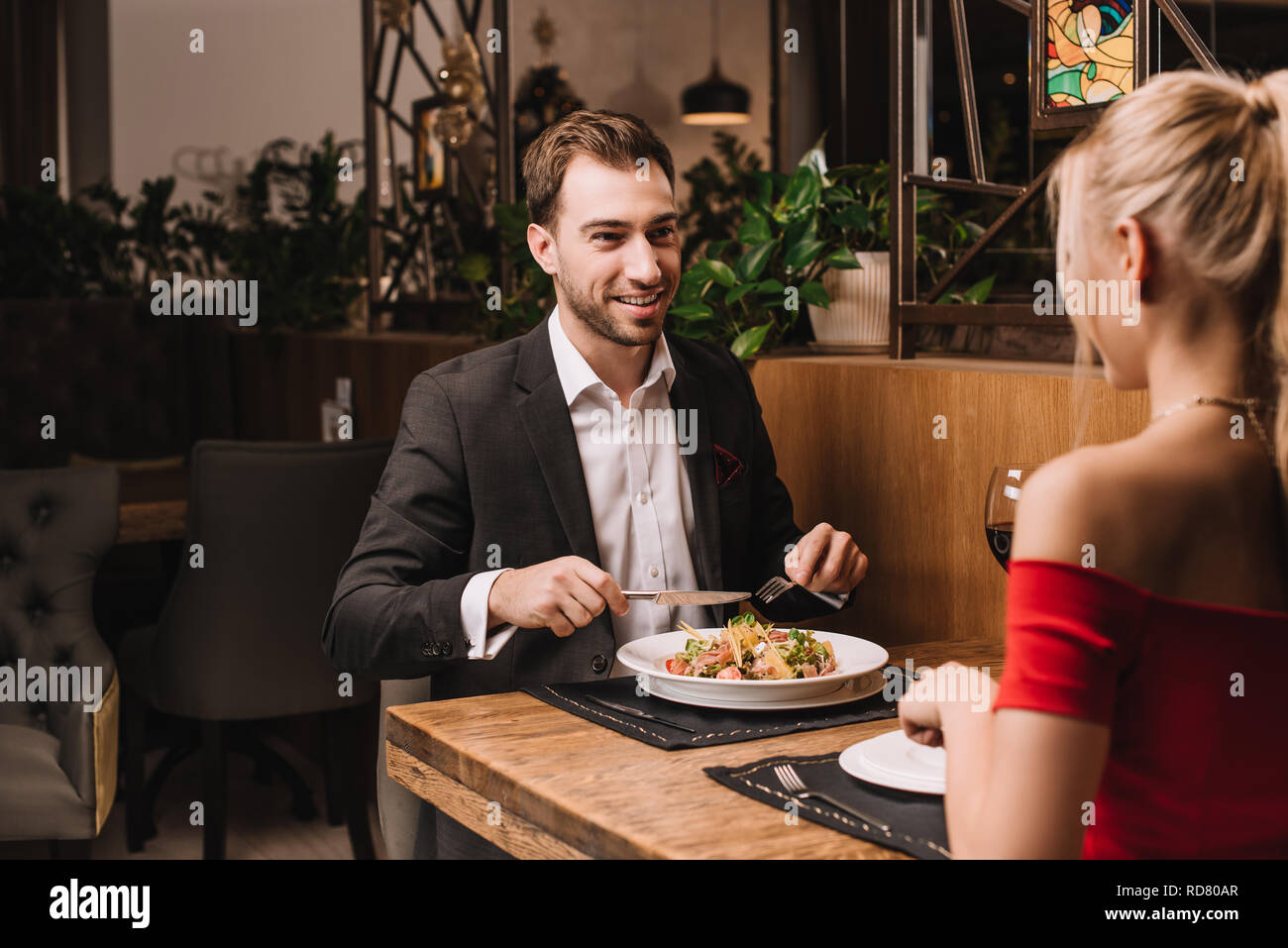 handsome man having dinner with girlfriend in restaurant Stock Photo ...