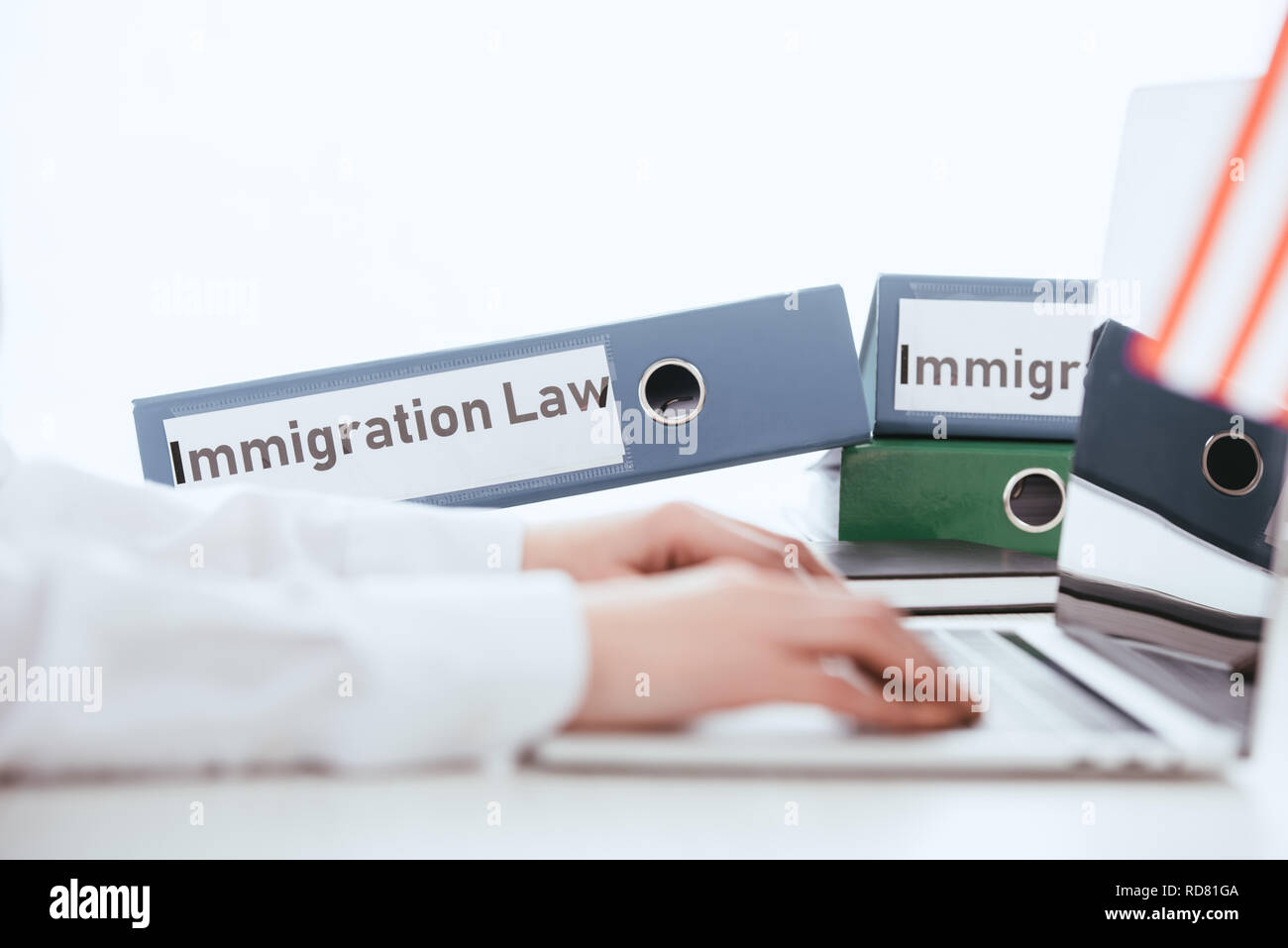 selective focus of folders with immigration law lettering near woman ...