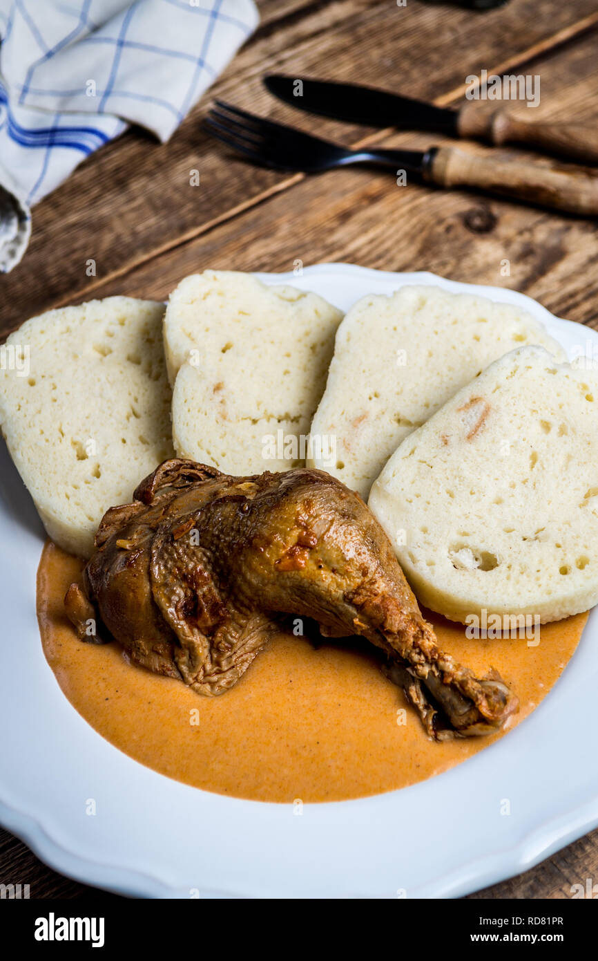 Traditional Czech cuisine chicken thigh on red pepper sauce with ...