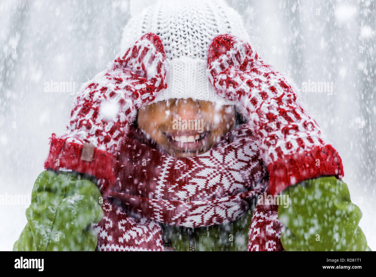 close up view of smiling african american child with knitted hat pulled ...