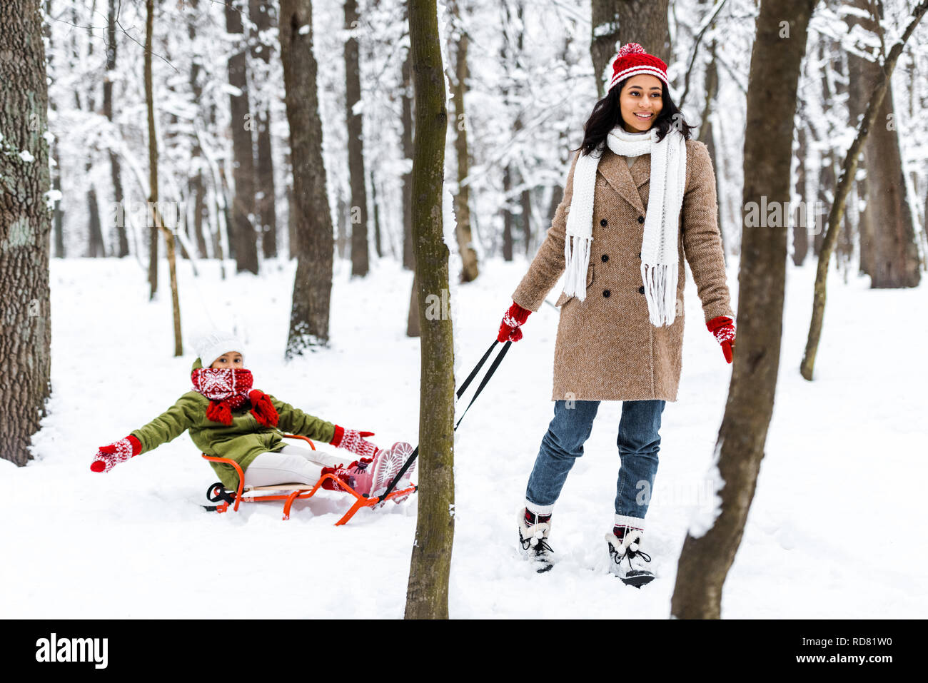 beautiful african american woman smiling and pulling preteen daughter ...