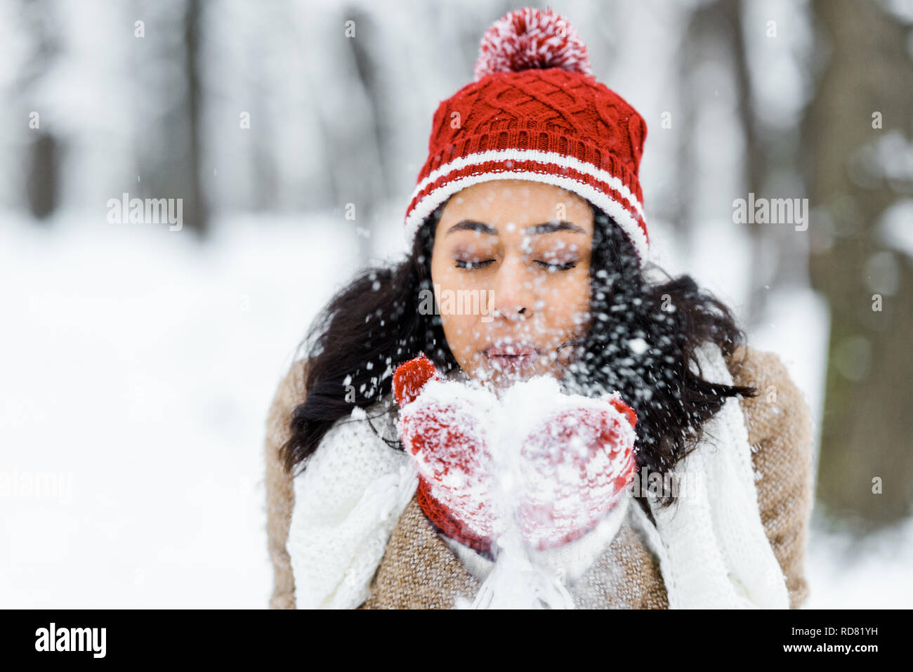 Beautiful woman blowing in snow hi-res stock photography and images - Alamy