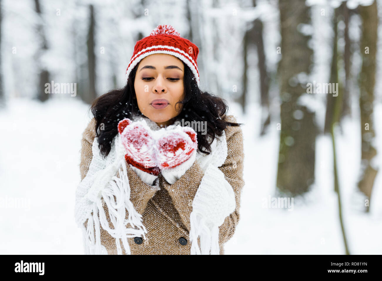 Beautiful woman blowing in snow hi-res stock photography and images - Alamy
