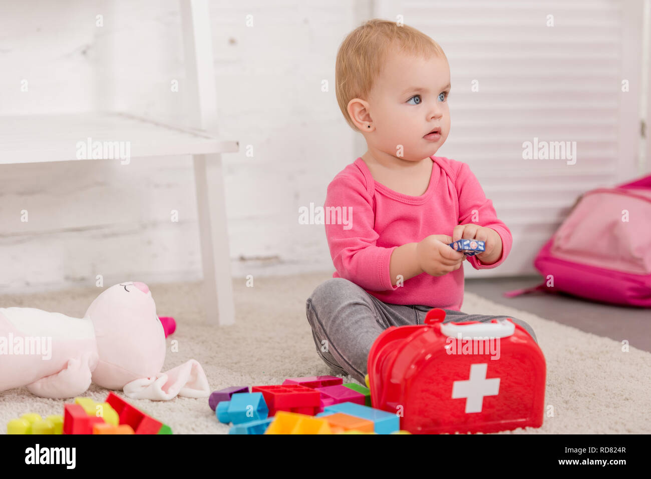 adorable child playing with first aid kit in children room Stock Photo ...
