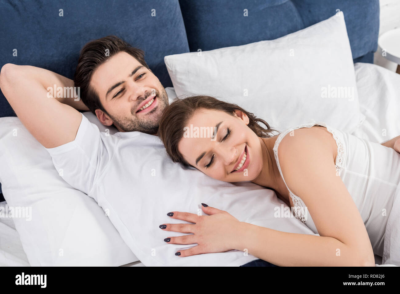 Couples Cuddling In Bed