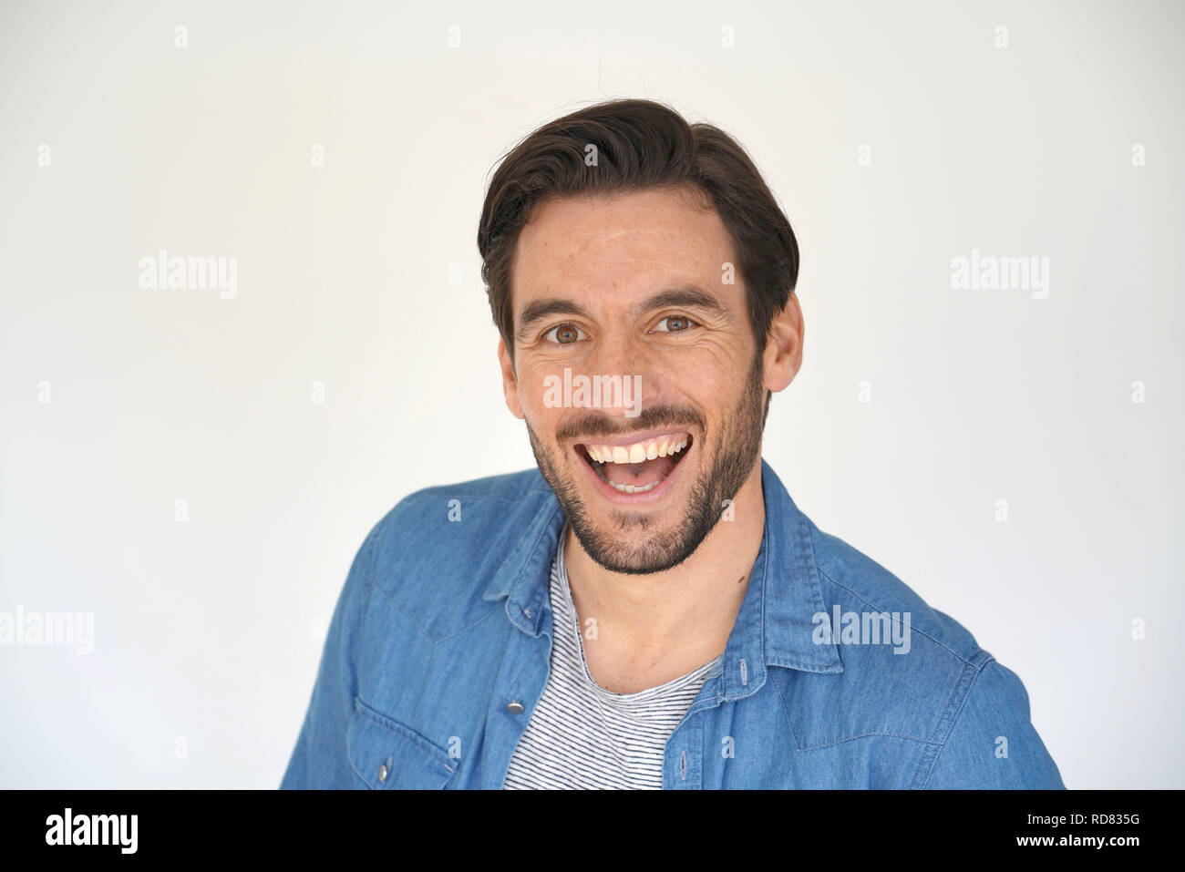 Portrait of casual laughing handsome man on white background Stock ...
