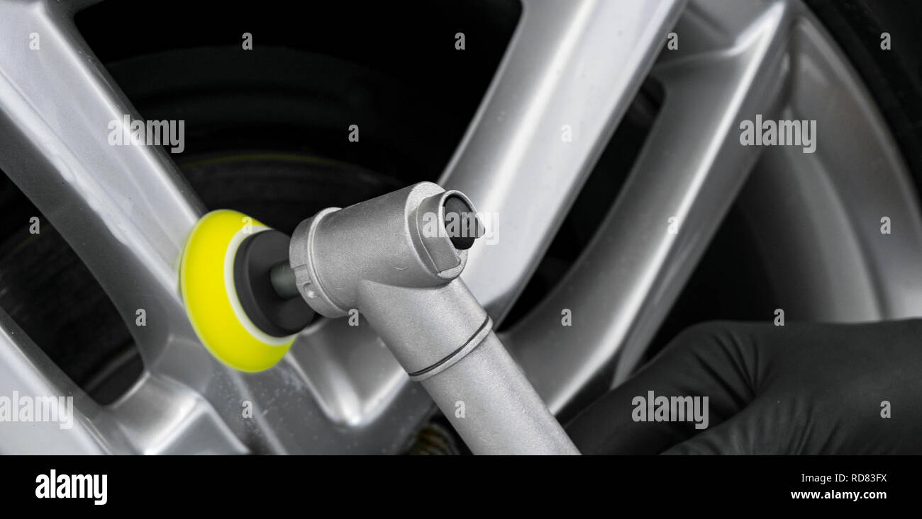 Car polish wax worker hands polishing wheel. Buffing and polishing car ...