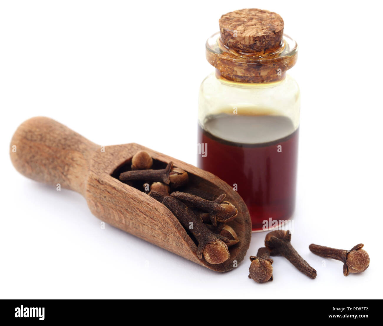 Fresh clove with oil in a jar over white background Stock Photo - Alamy