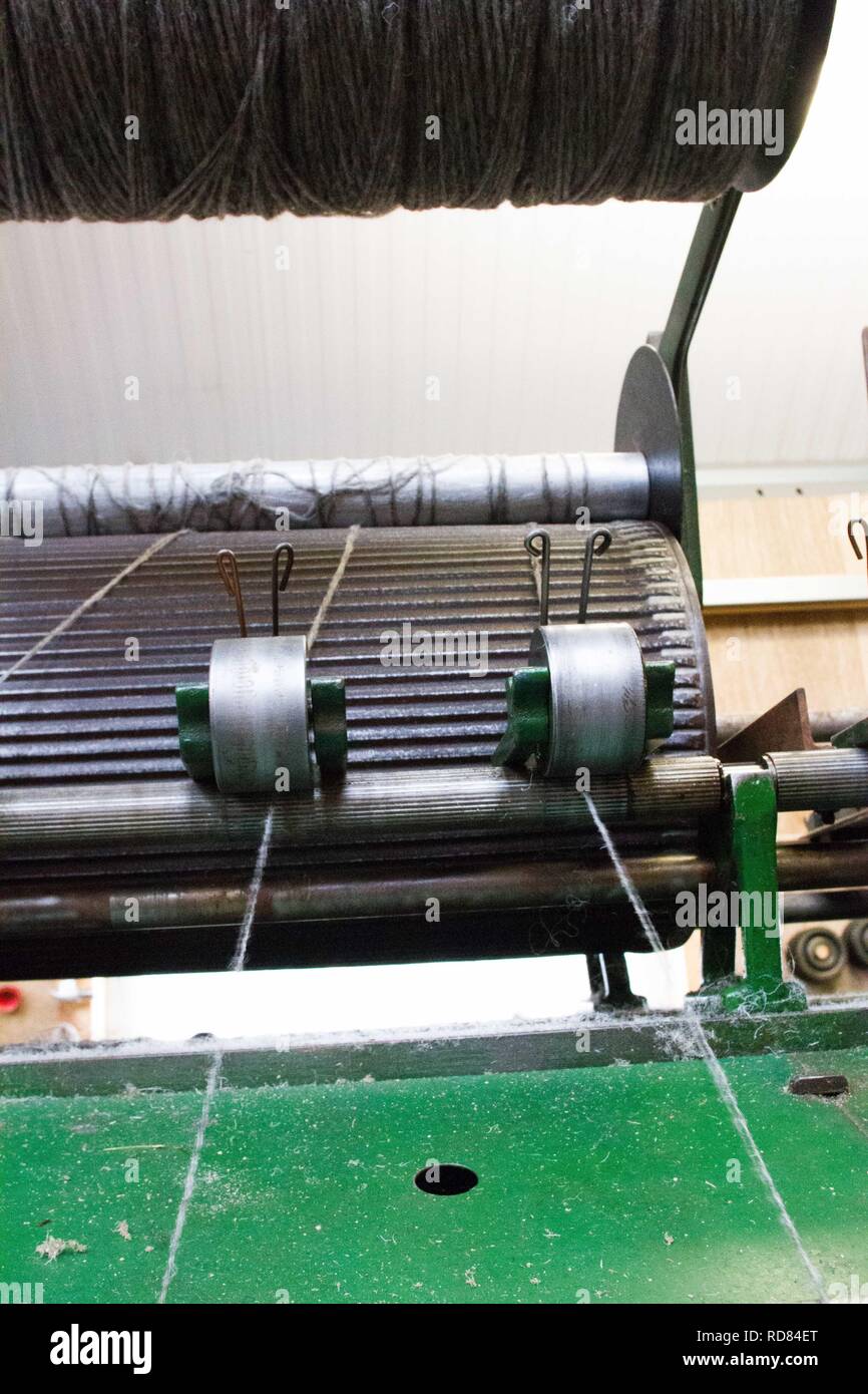 Highly skilled Swedish woman using restored wool and textile machines ...