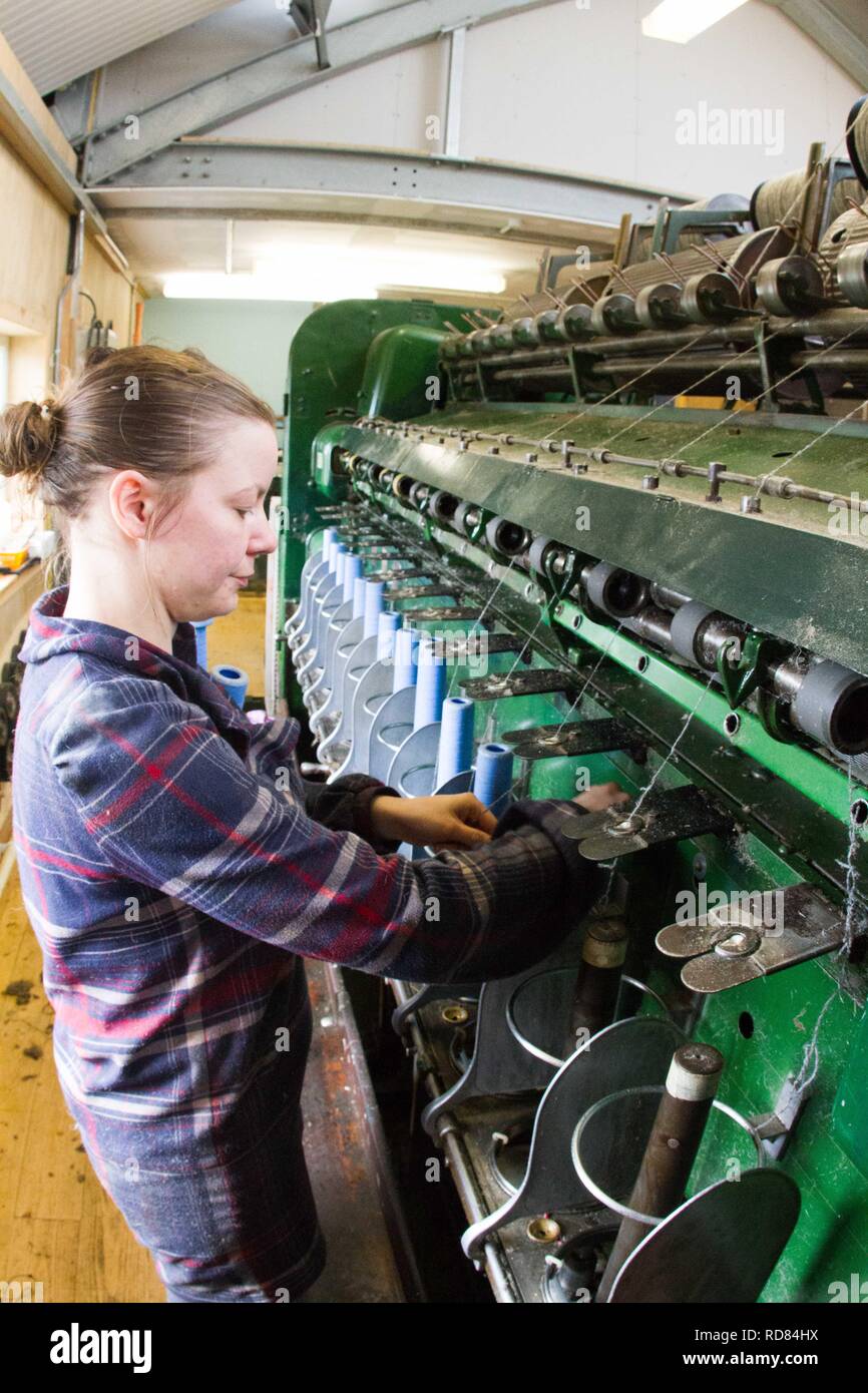 Highly skilled Swedish woman using restored wool and textile machines ...