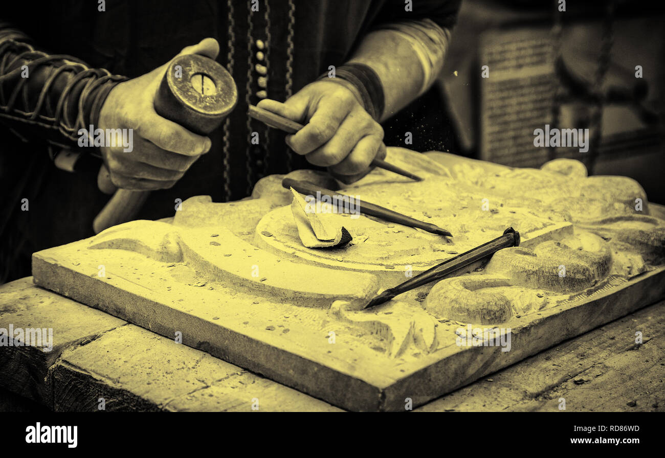 Carving stone in a traditional way, craftsmanship detail, shaping the ...