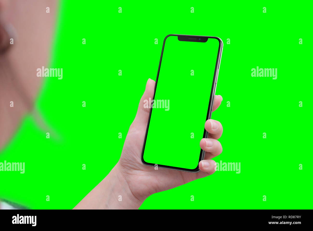 Modern smart phone with round edges in hand. Close-up. Isoalted screen ...