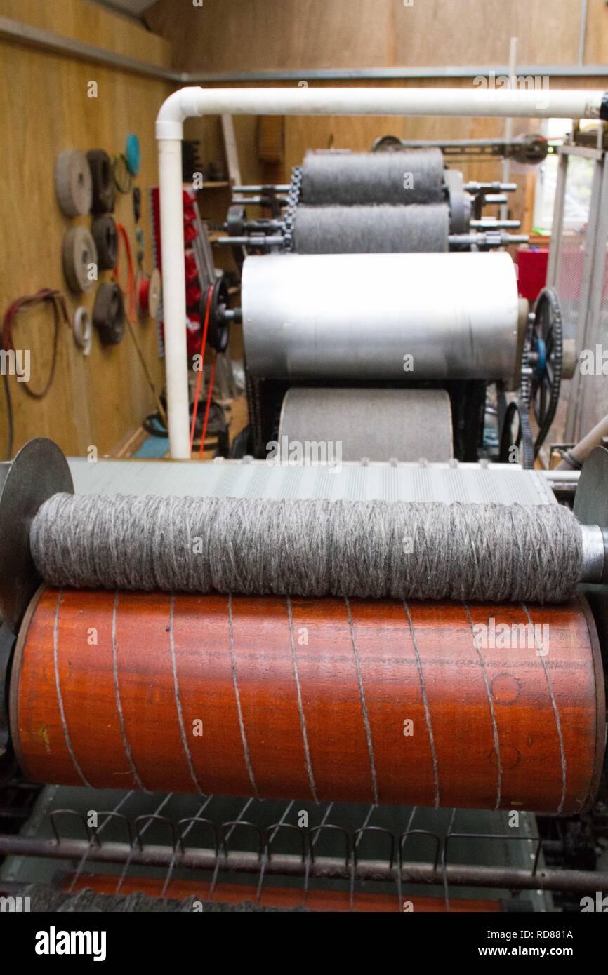 Wool thread being spun from raw wool product , part of process to ...
