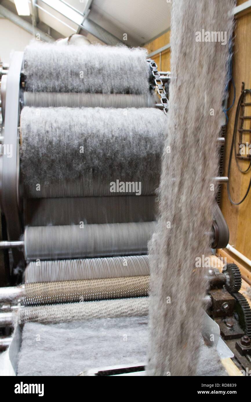 Wool thread being spun from raw wool product , part of process to ...