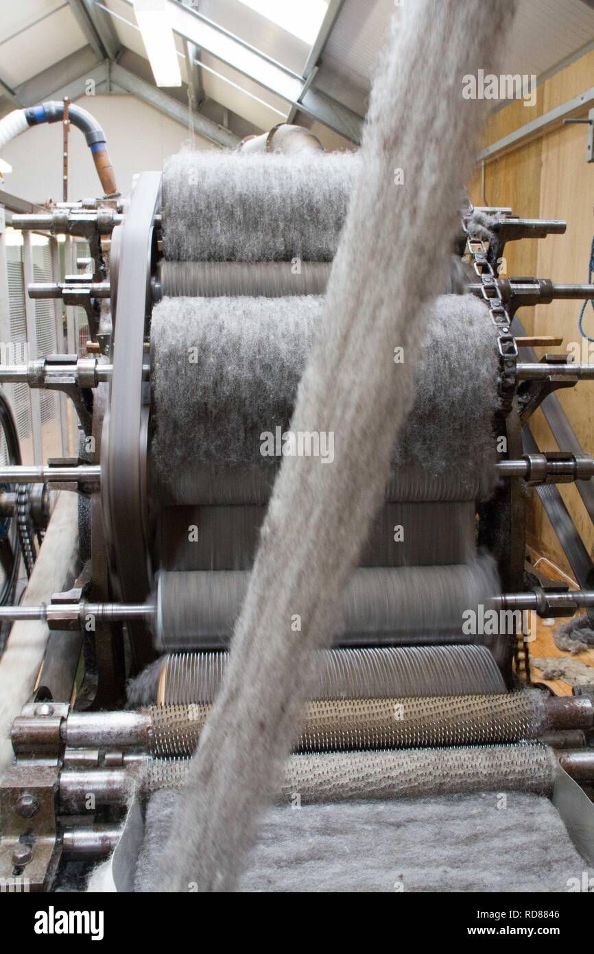 Wool thread being spun from raw wool product , part of process to ...