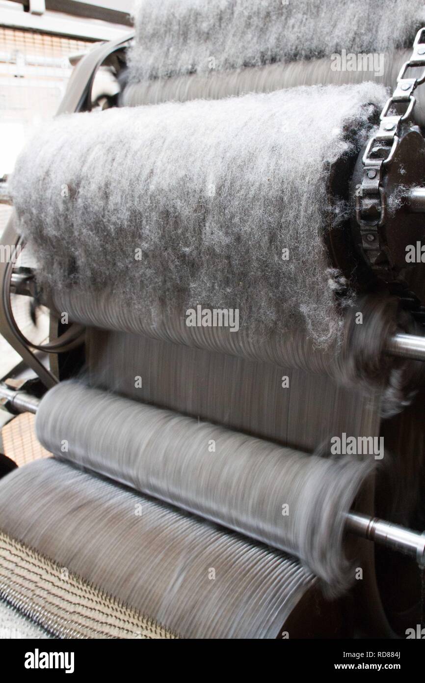 Wool thread being spun from raw wool product , part of process to ...