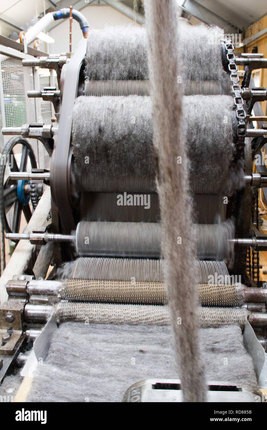 Wool thread being spun from raw wool product , part of process to ...
