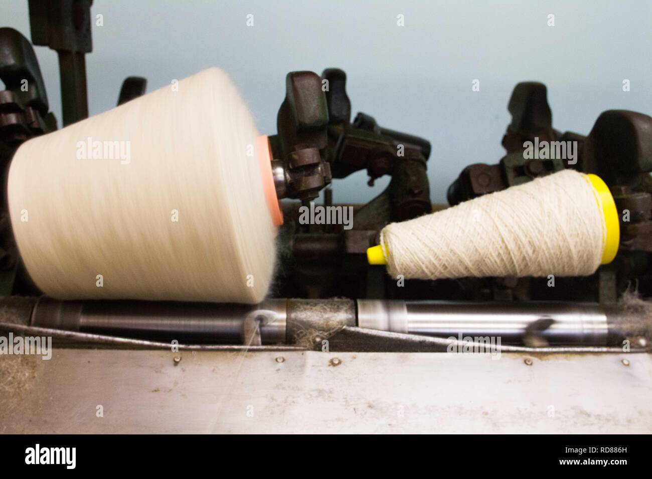 Highly skilled Swedish woman using restored wool and textile machines ...