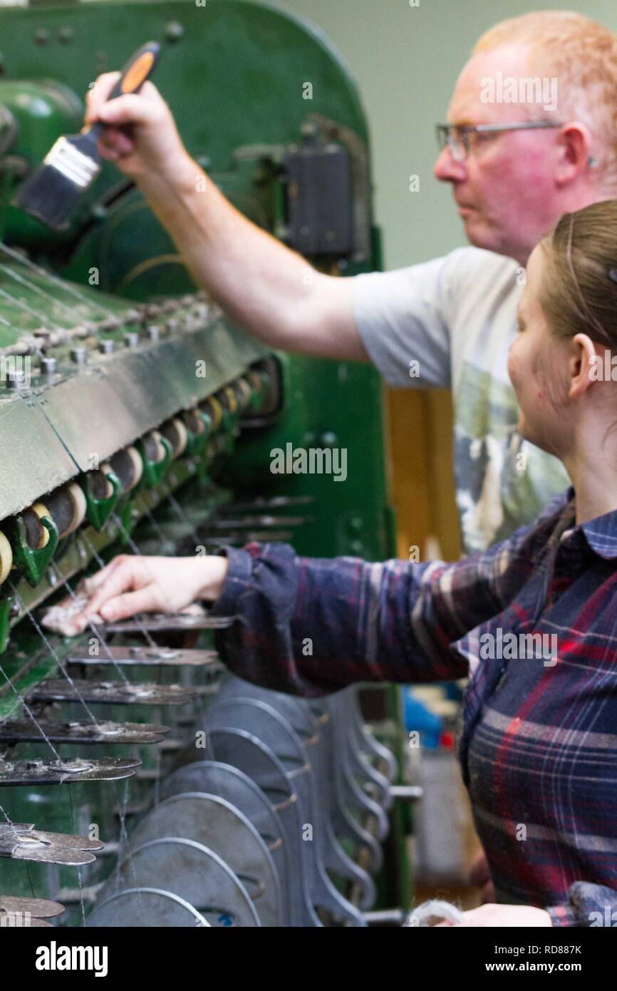 Highly skilled Swedish woman using restored wool and textile machines ...