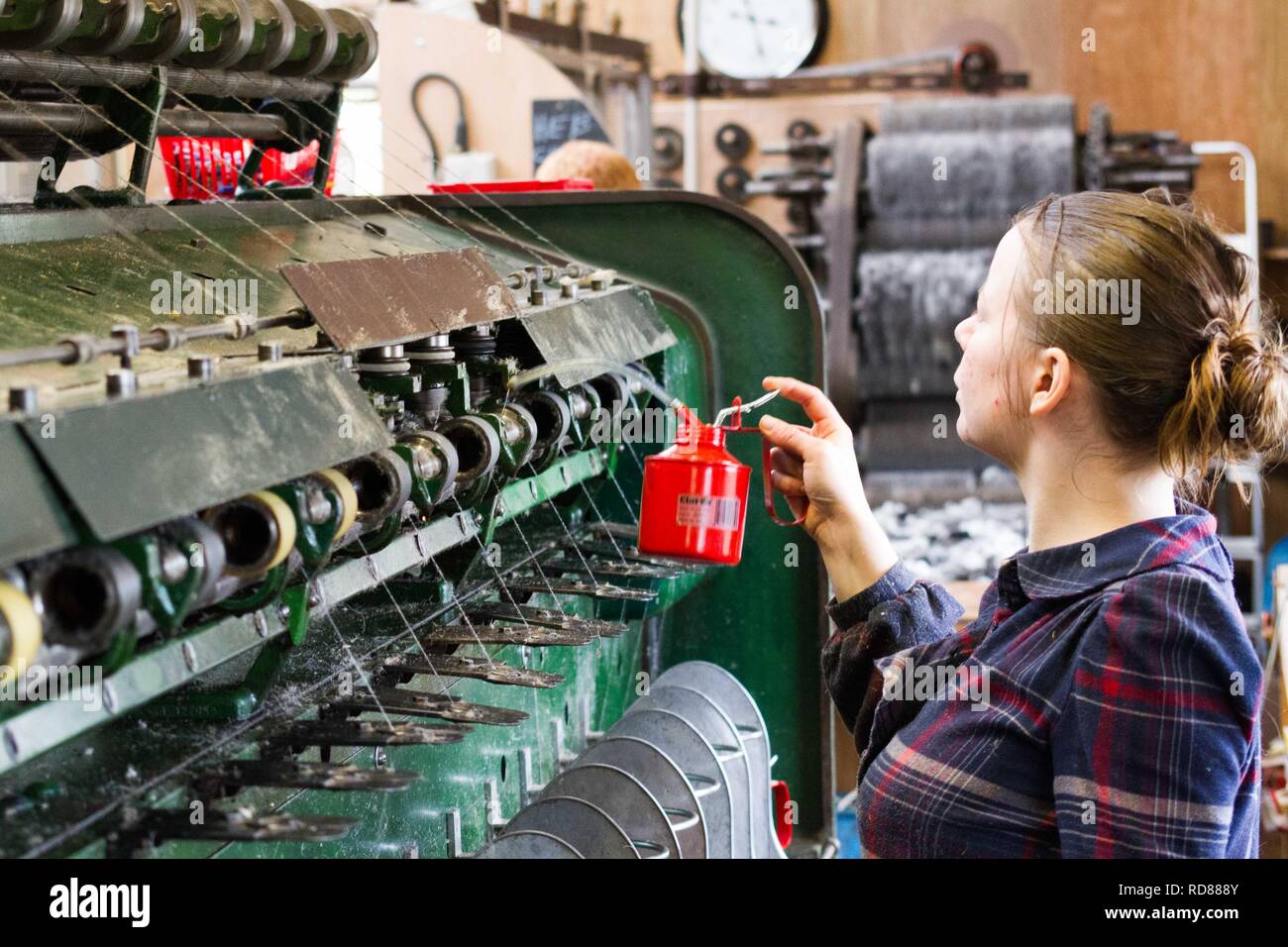 Highly skilled Swedish woman using restored wool and textile machines ...