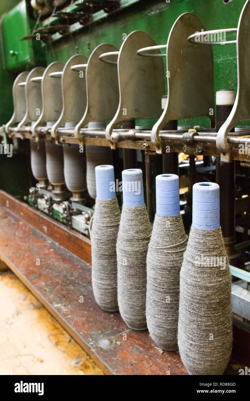 Highly skilled Swedish woman using restored wool and textile machines ...