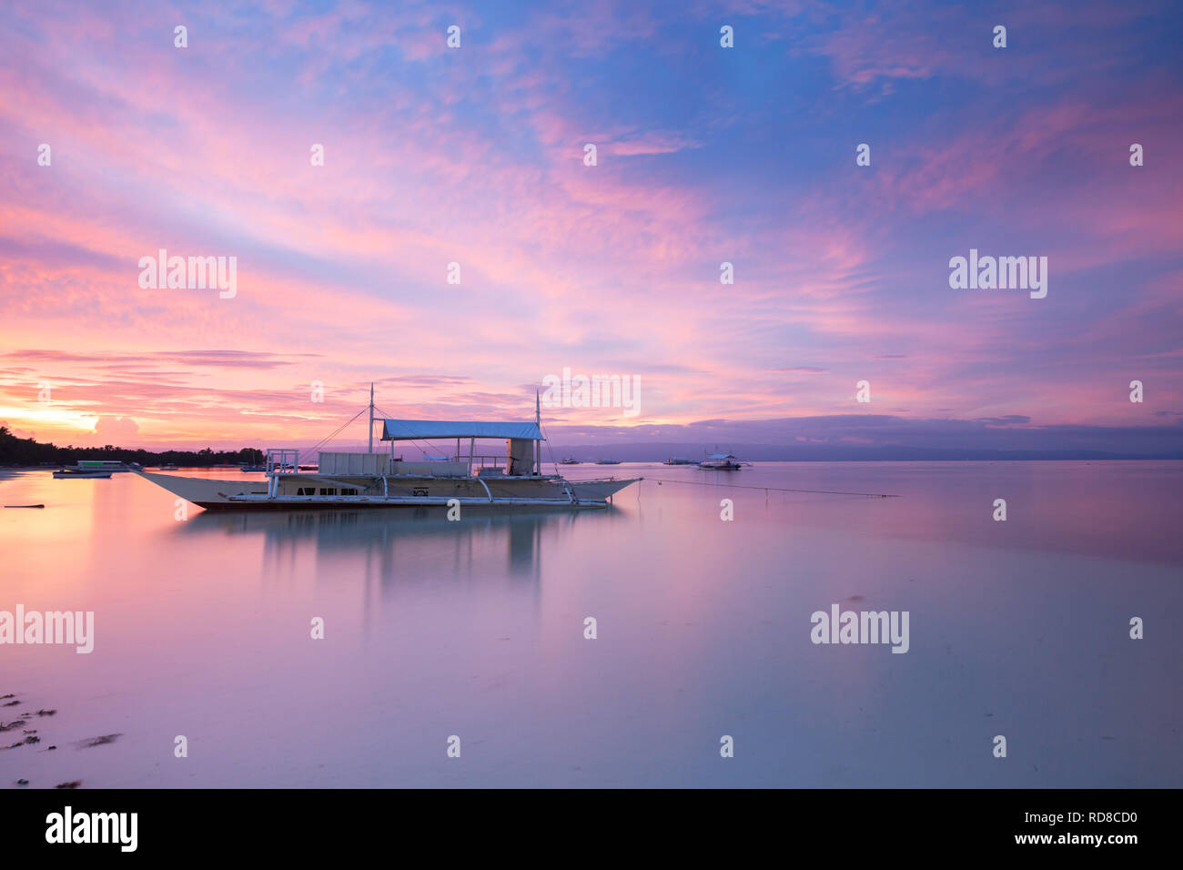 Sunset view of the Dolho Beach with traditional bangka boat, Panglao ...
