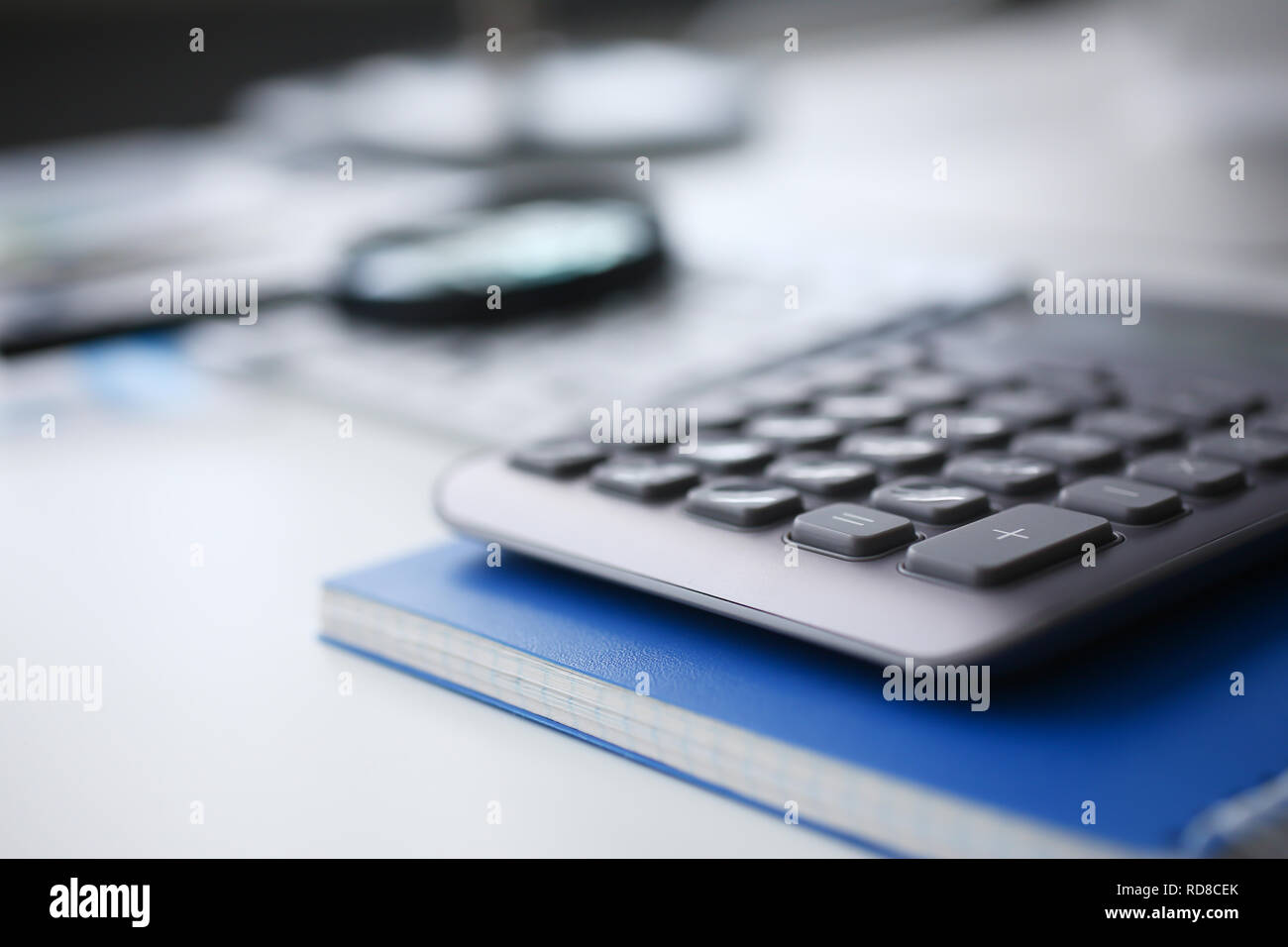 Silver calculator and financial statistics on clipboard Stock Photo - Alamy