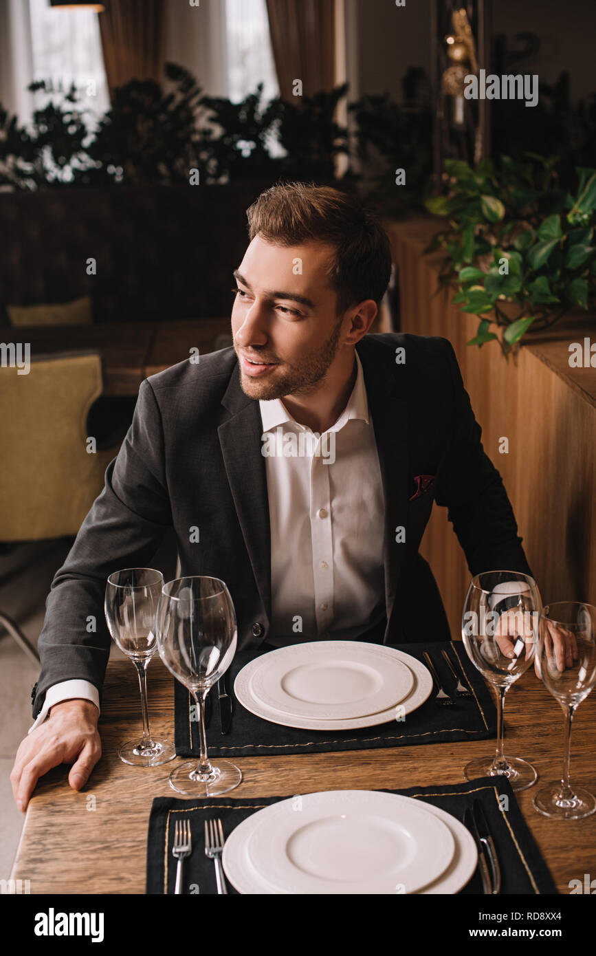 Smiling handsome man waiting girlfriend hi-res stock photography and ...