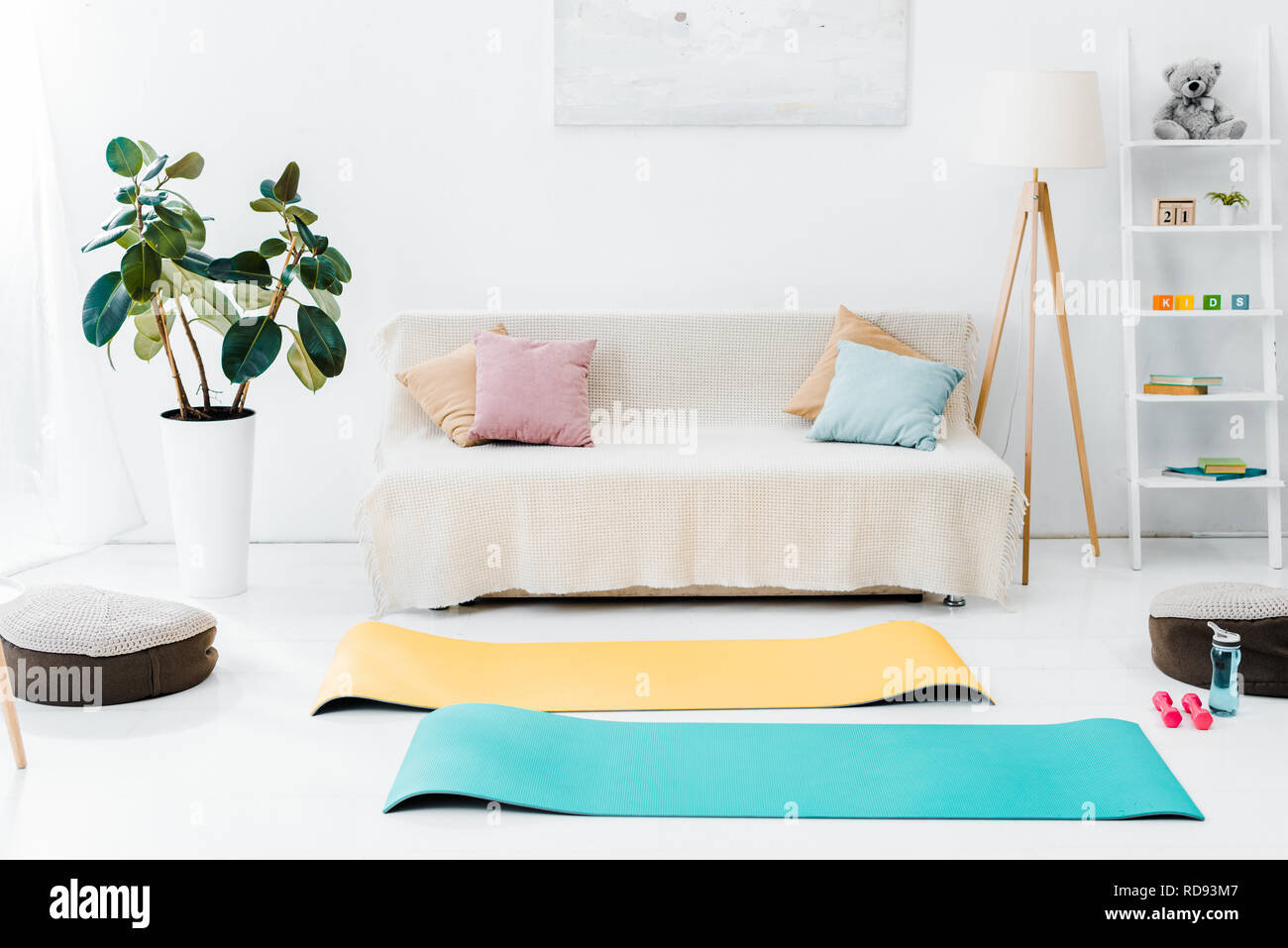 interior of living room with fitness mats and sport equipment on floor ...