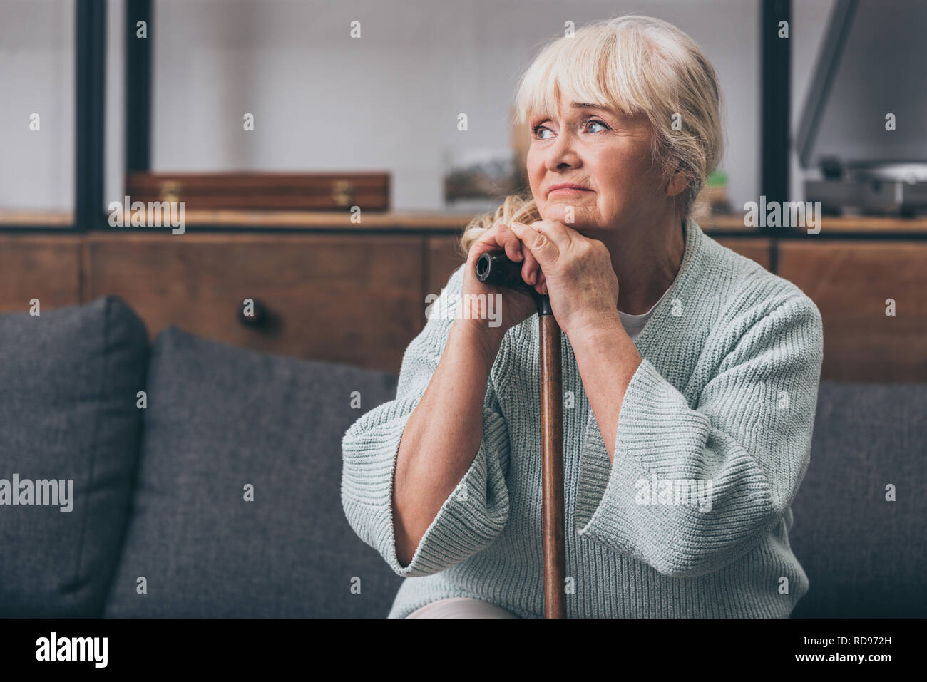 sad senior woman with walking cane at home Stock Photo - Alamy