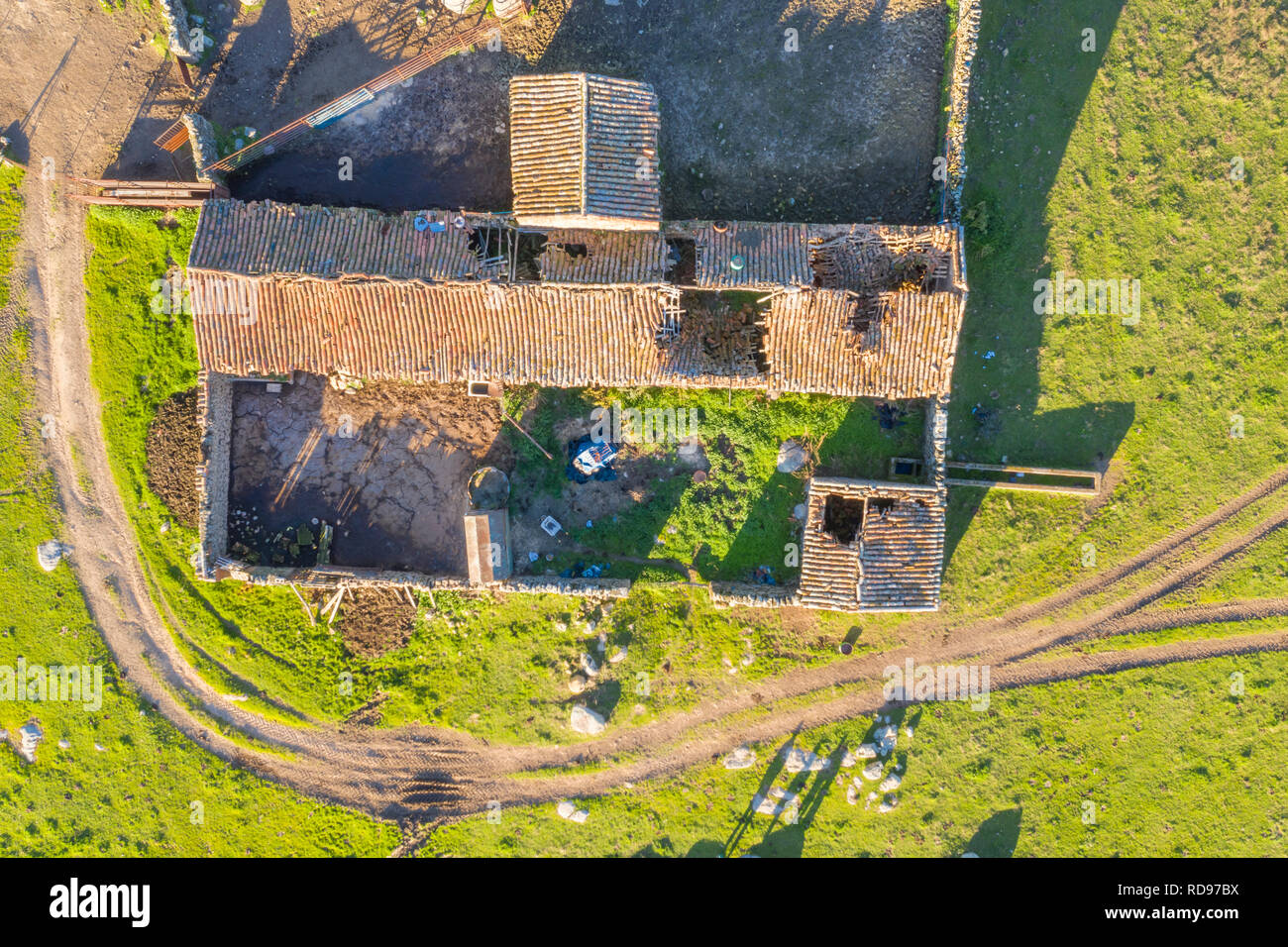 Aerial overhead view of an old shed in ruins with some tiles from the ...