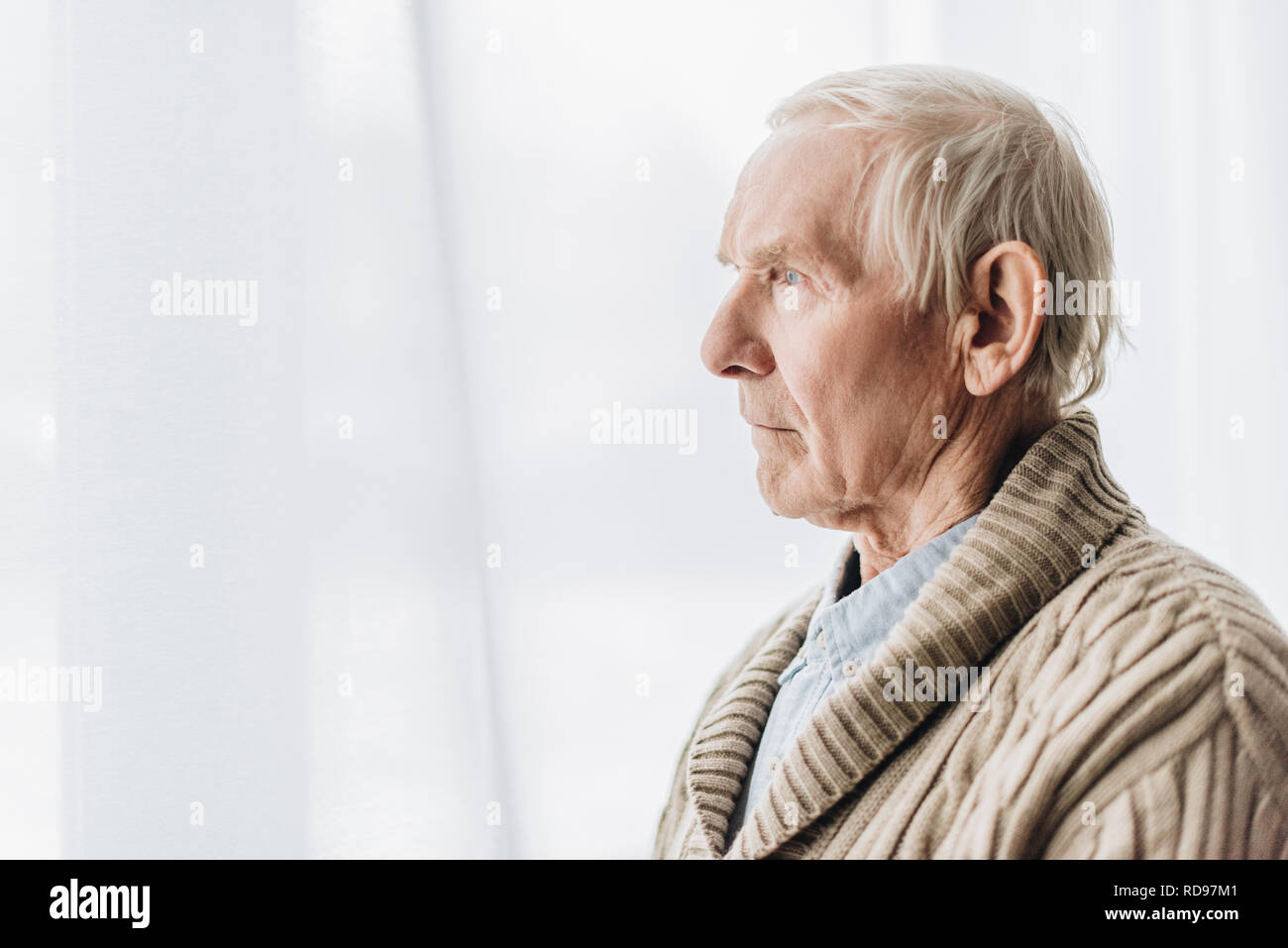 sad senior man with dementia disease at home Stock Photo - Alamy