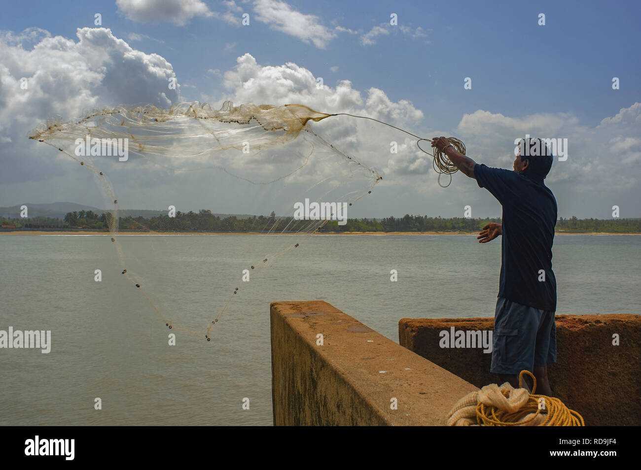 11-Jun-2009-Fisherman throwing net in Arabian sea at Vengurla ; Aruali ...