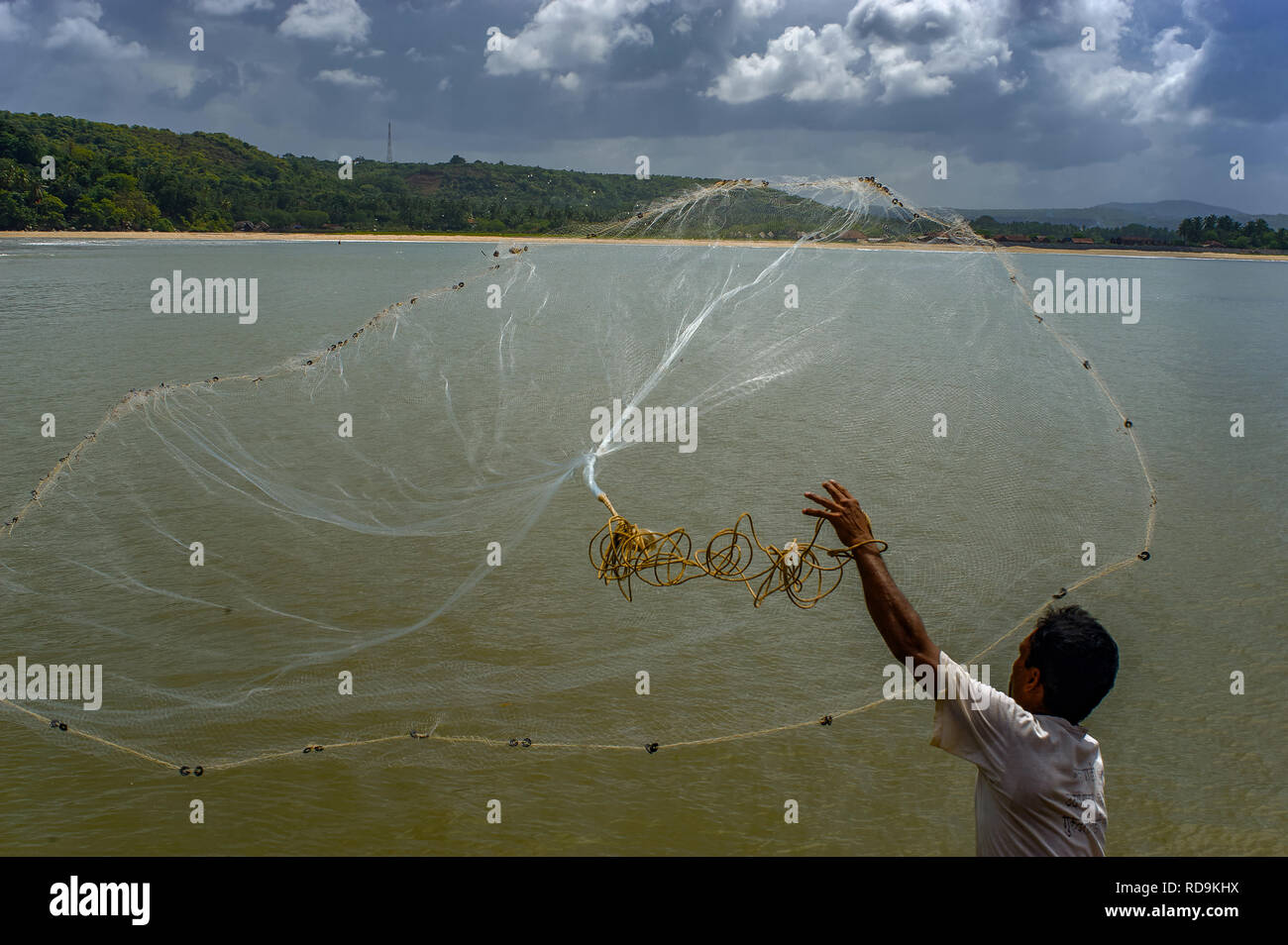 11-Jun-2009-Fisherman throwing net in Arabian sea at Vengurla ; Aruali ...