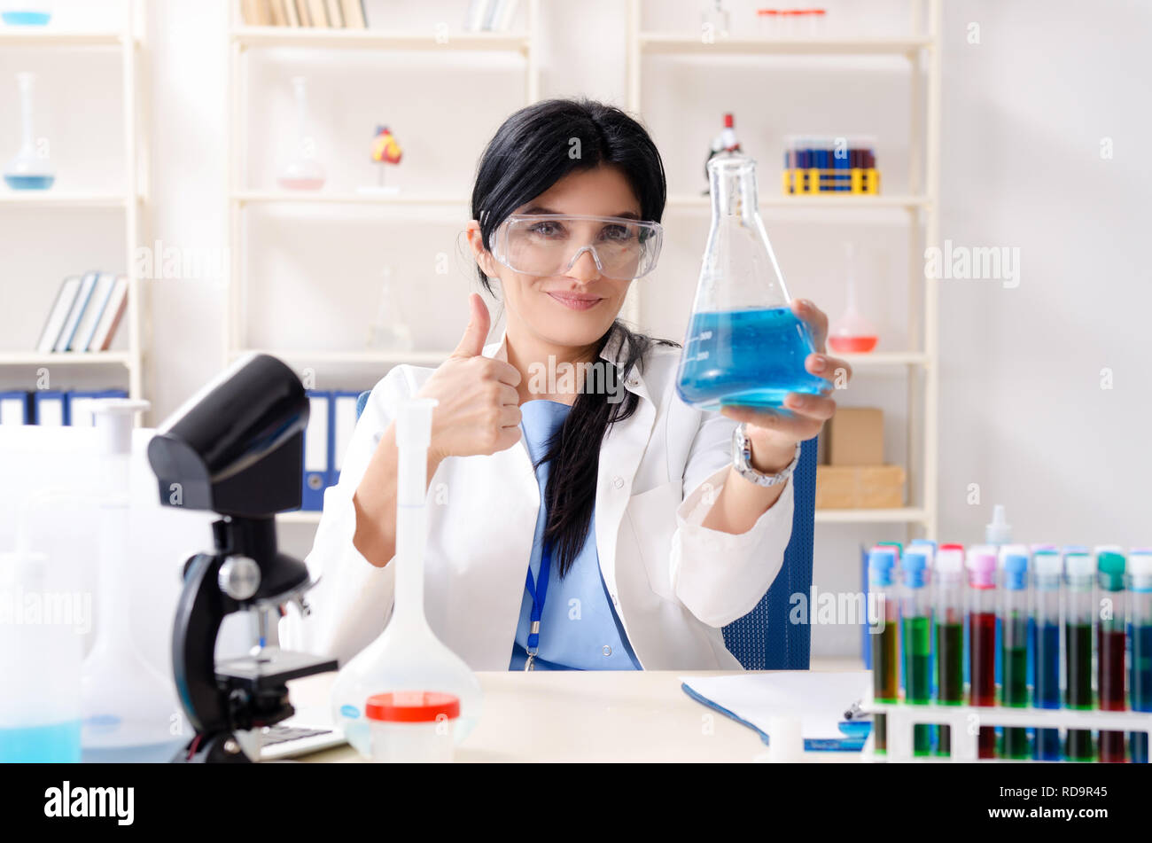 Female chemist working at the lab Stock Photo - Alamy