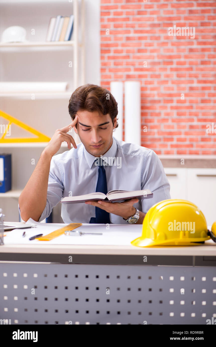 Construction supervisor working on blueprints Stock Photo - Alamy