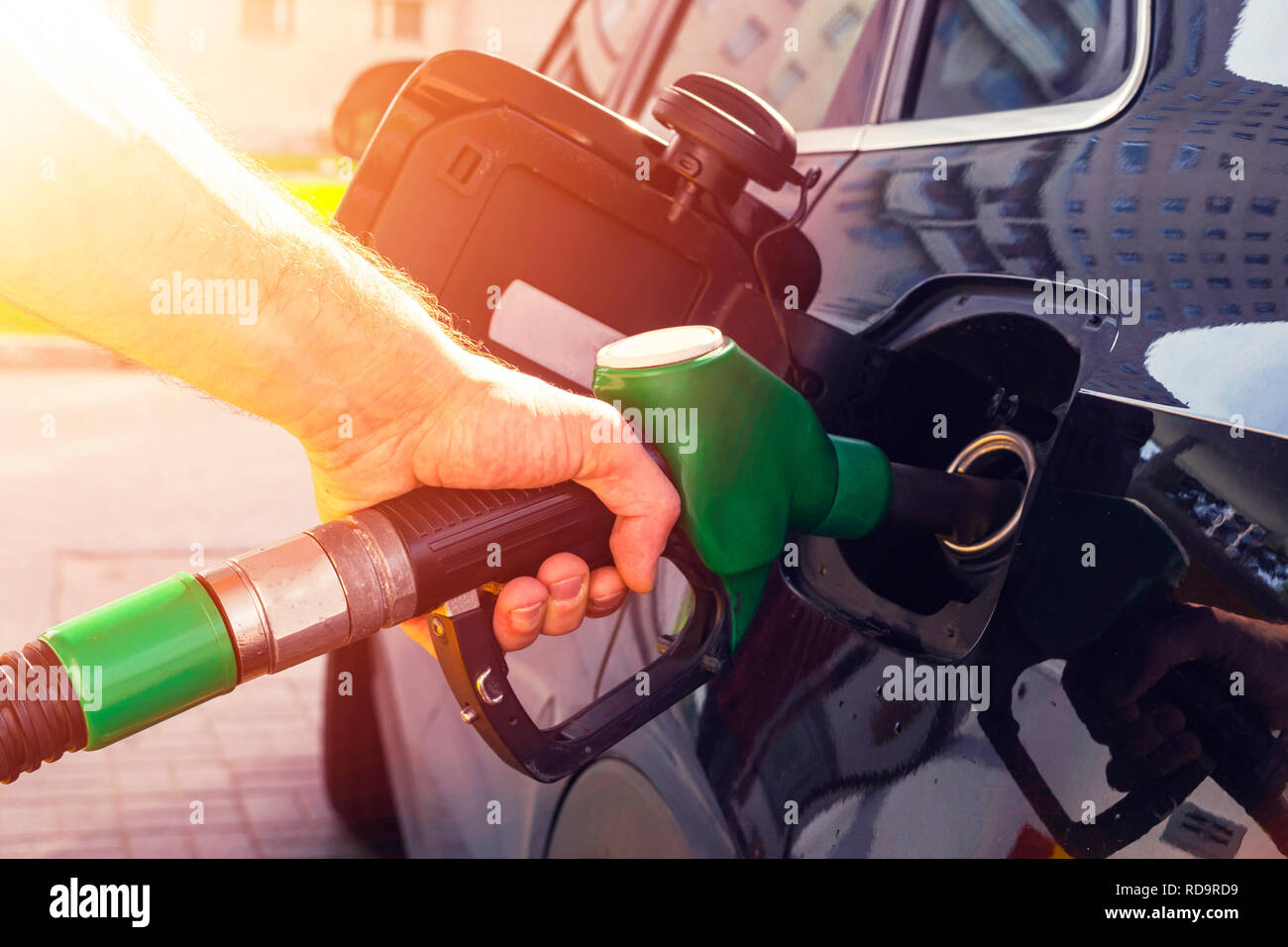 Refueling the car at a gas station fuel pump. Man driver hand refilling ...