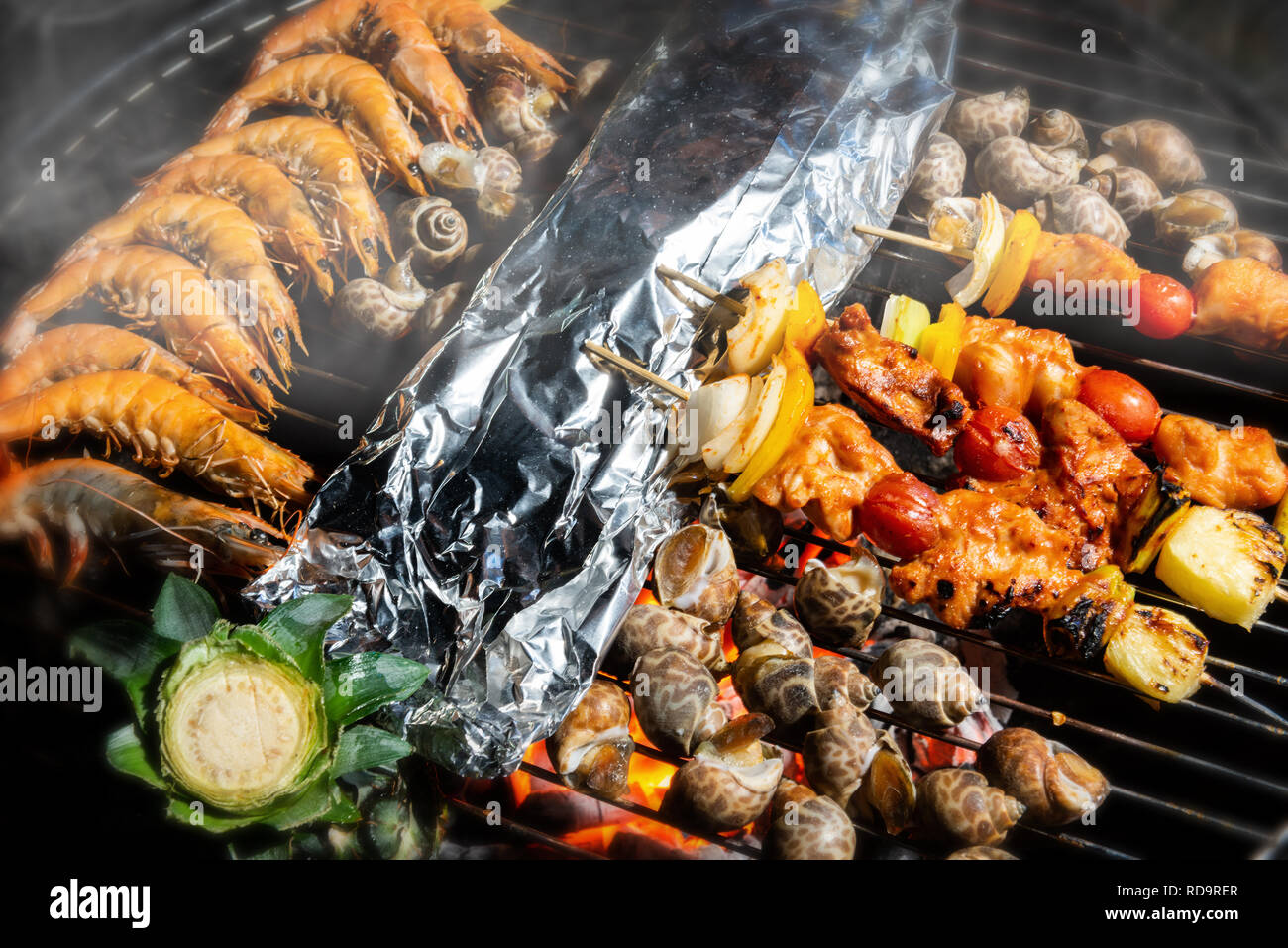 Grilled flame fire seafood and barbecue foods Stock Photo - Alamy