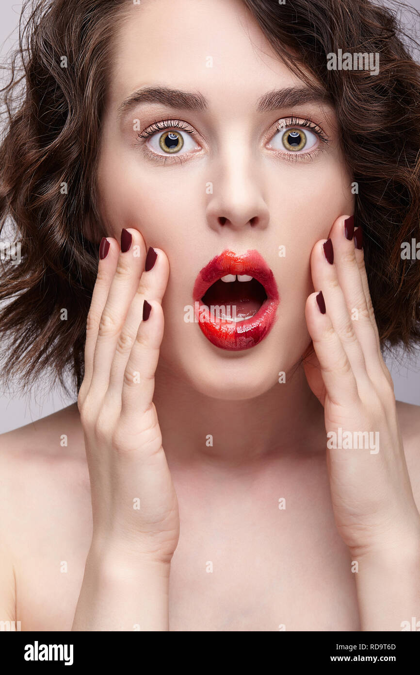 Closeup beauty portrait of young woman with hands near face. Brunette ...