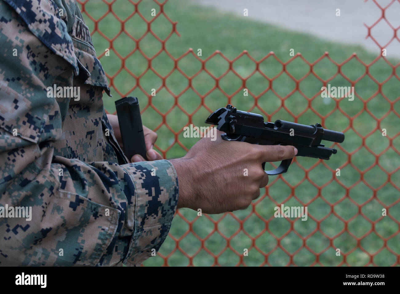 A U.S. Marine unloads and clears his M9 Beretta Pistol after a course ...