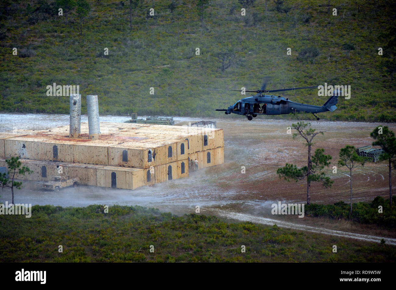 A 41st Rescue Squadron HH-60G Pave Hawk navigates over a mock ...