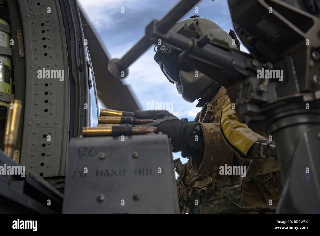 A 41st Rescue Squadron special missions aviator loads ammunition into ...