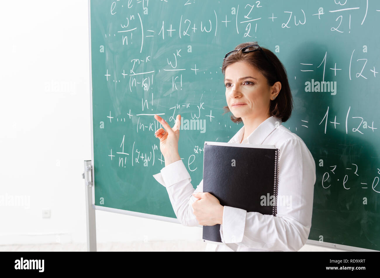 Female math teacher in front of the chalkboard Stock Photo - Alamy