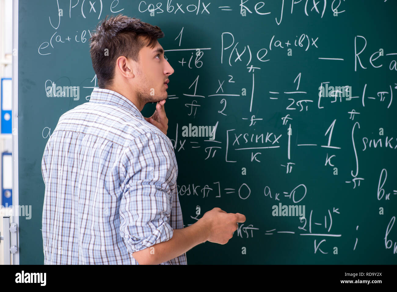 Young male student studying math at school Stock Photo - Alamy