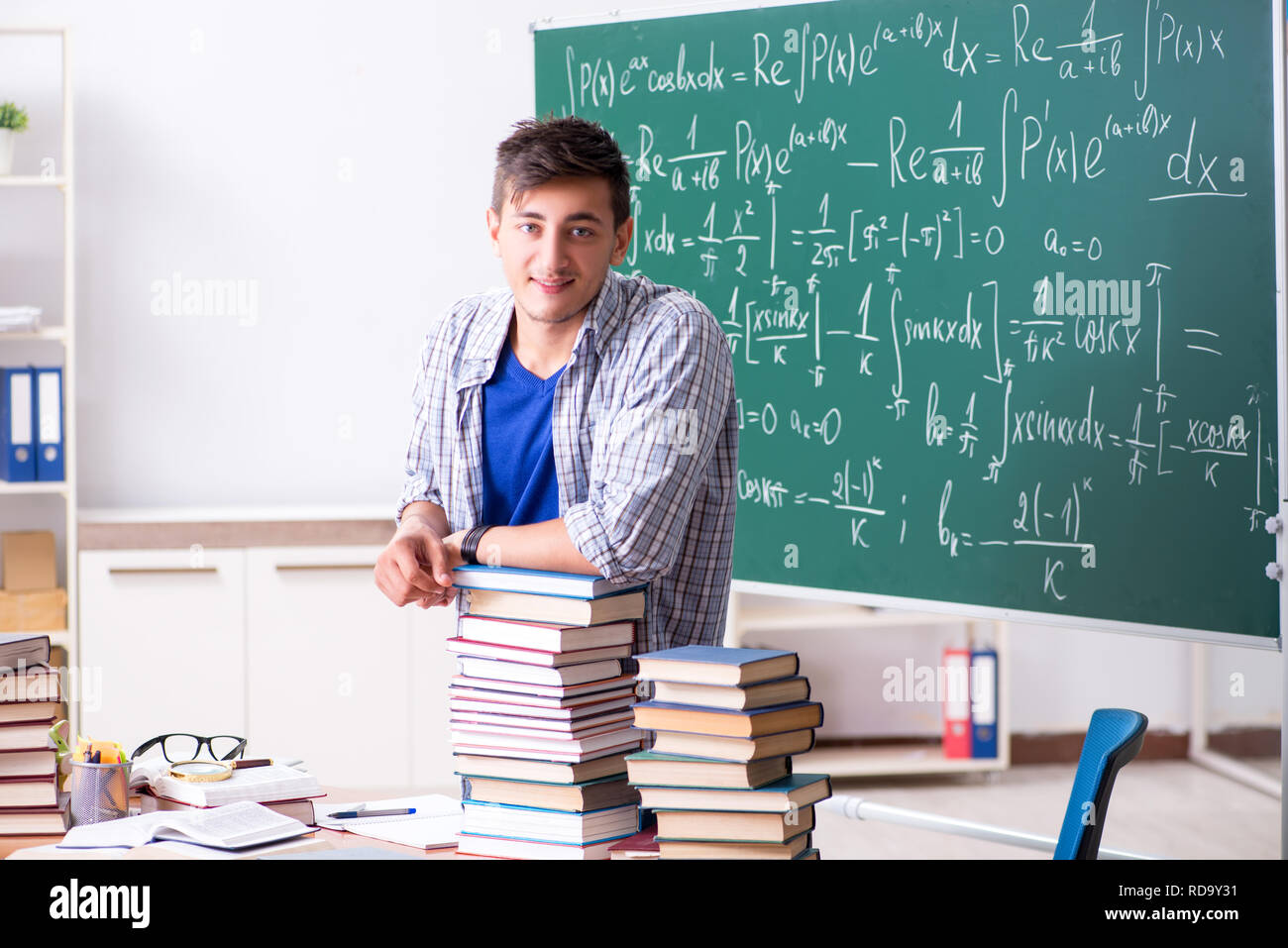 Young male student studying math at school Stock Photo - Alamy