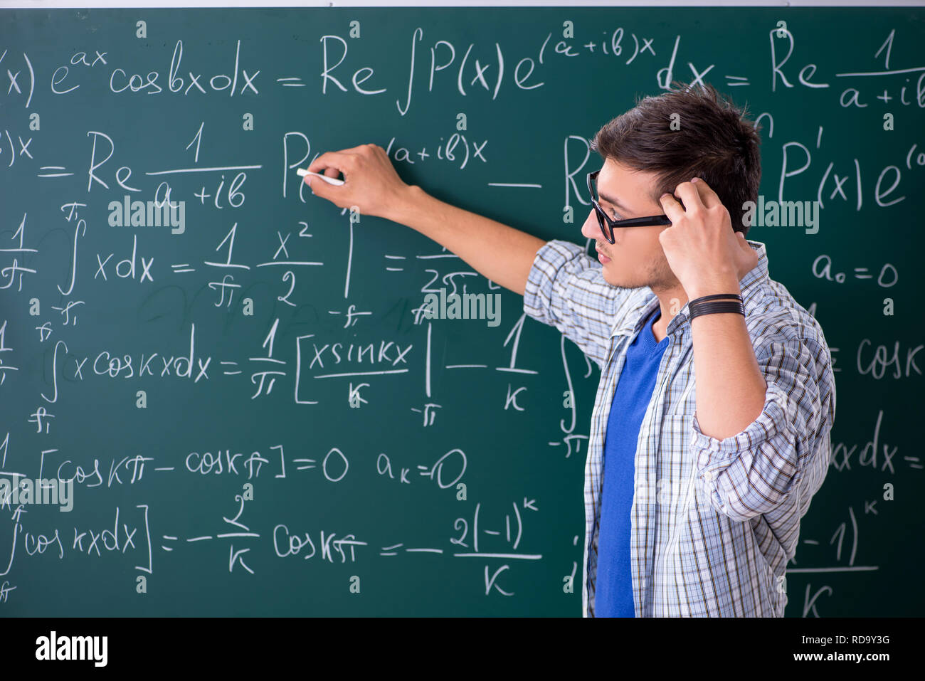 Young male student studying math at school Stock Photo - Alamy