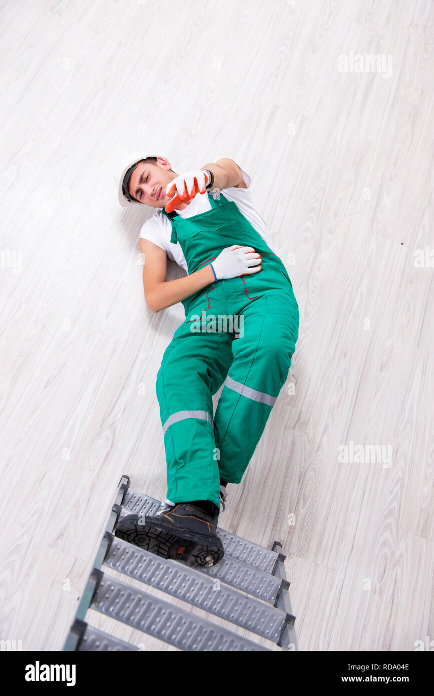Young worker falling from the ladder Stock Photo - Alamy
