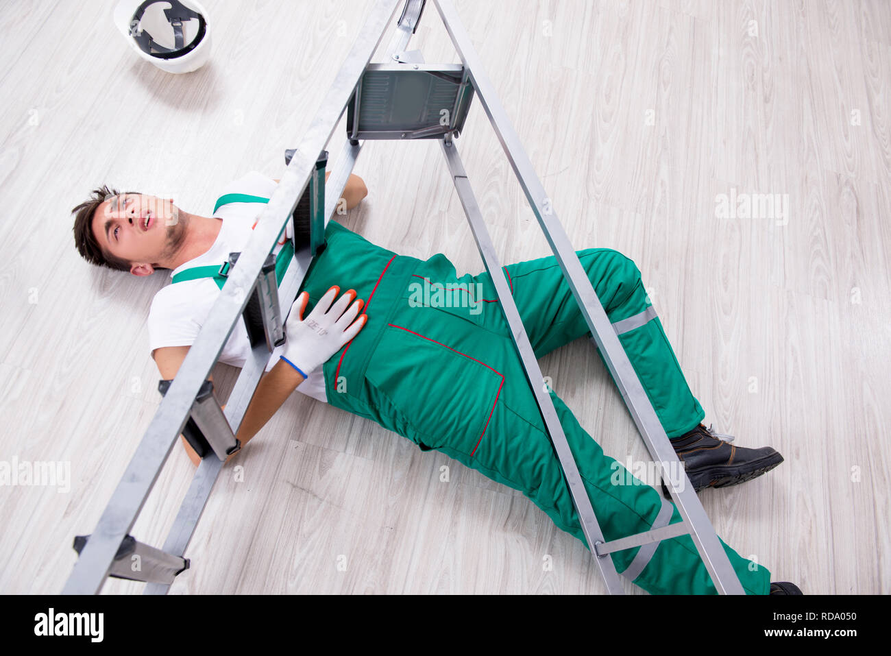 Young worker falling from the ladder Stock Photo - Alamy