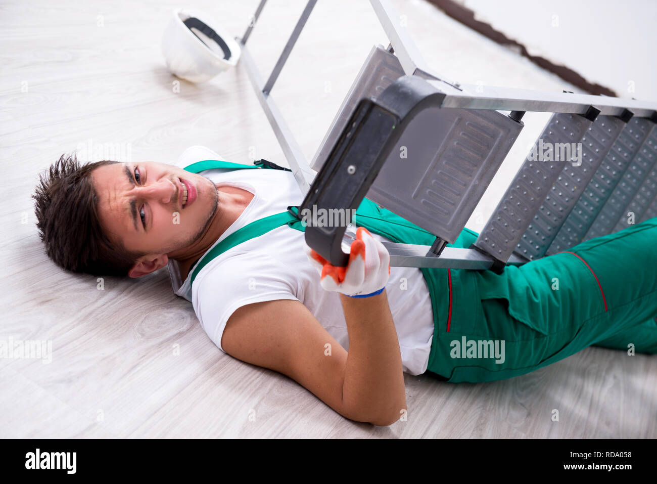 Young worker falling from the ladder Stock Photo - Alamy