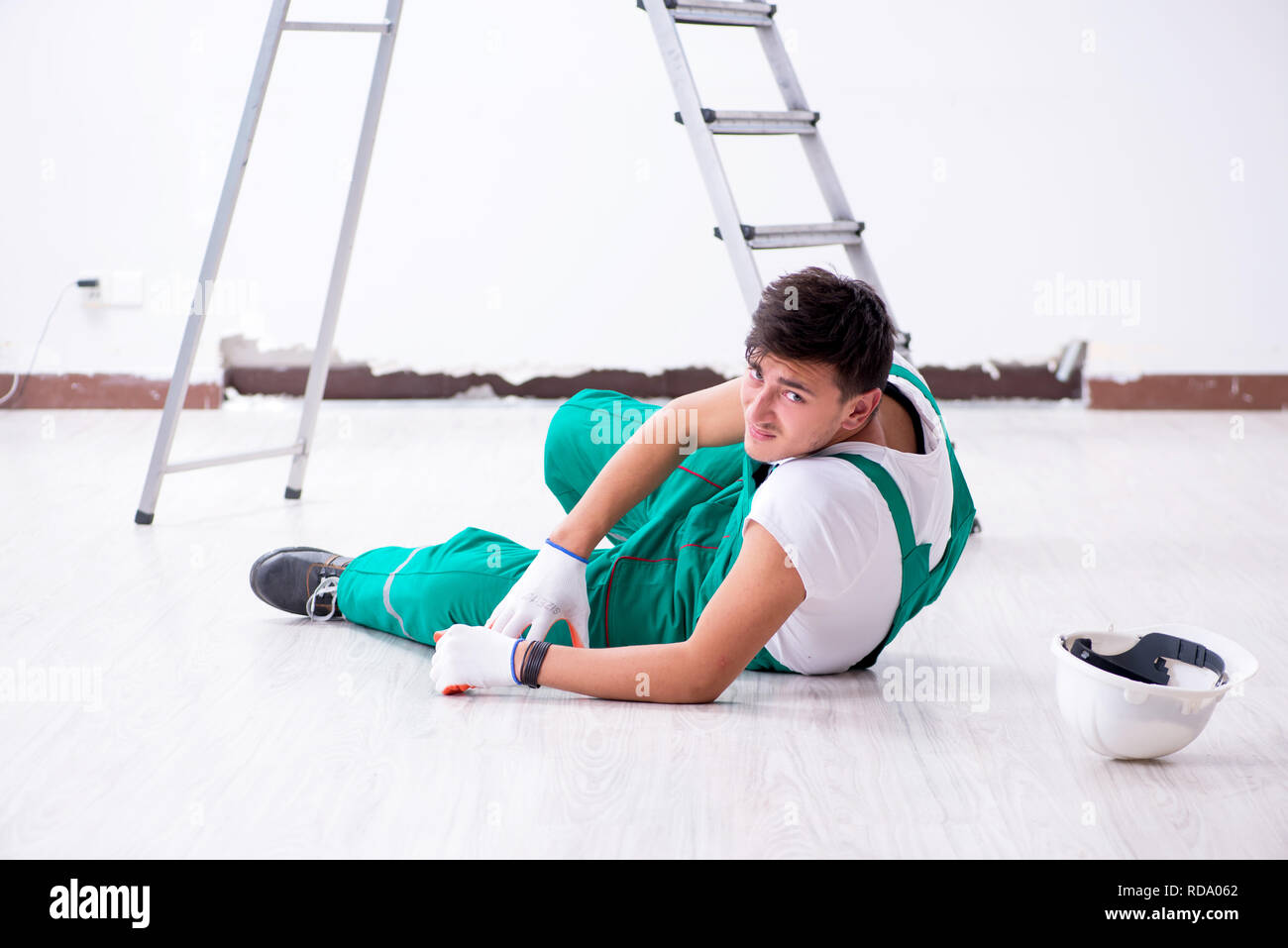 Young worker falling from the ladder Stock Photo - Alamy